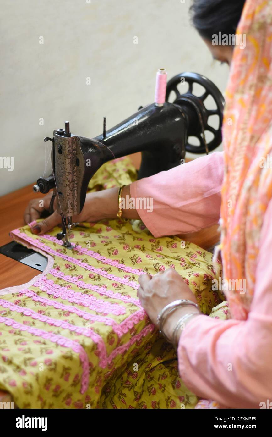 Indian woman stitching clothes using a sewing machine at home, Pune ...