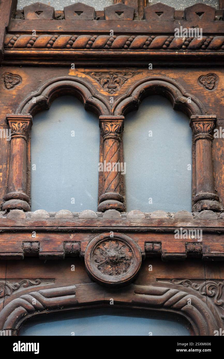 Ornate wooden facade in Bucharest reveals detailed carvings and arches ...