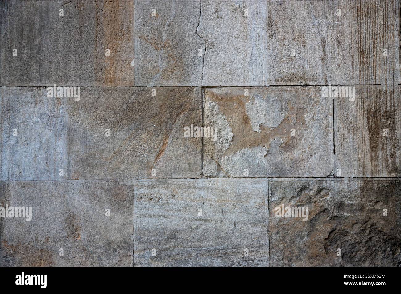 The textured stone wall reveals a unique blend of dark shades and ...