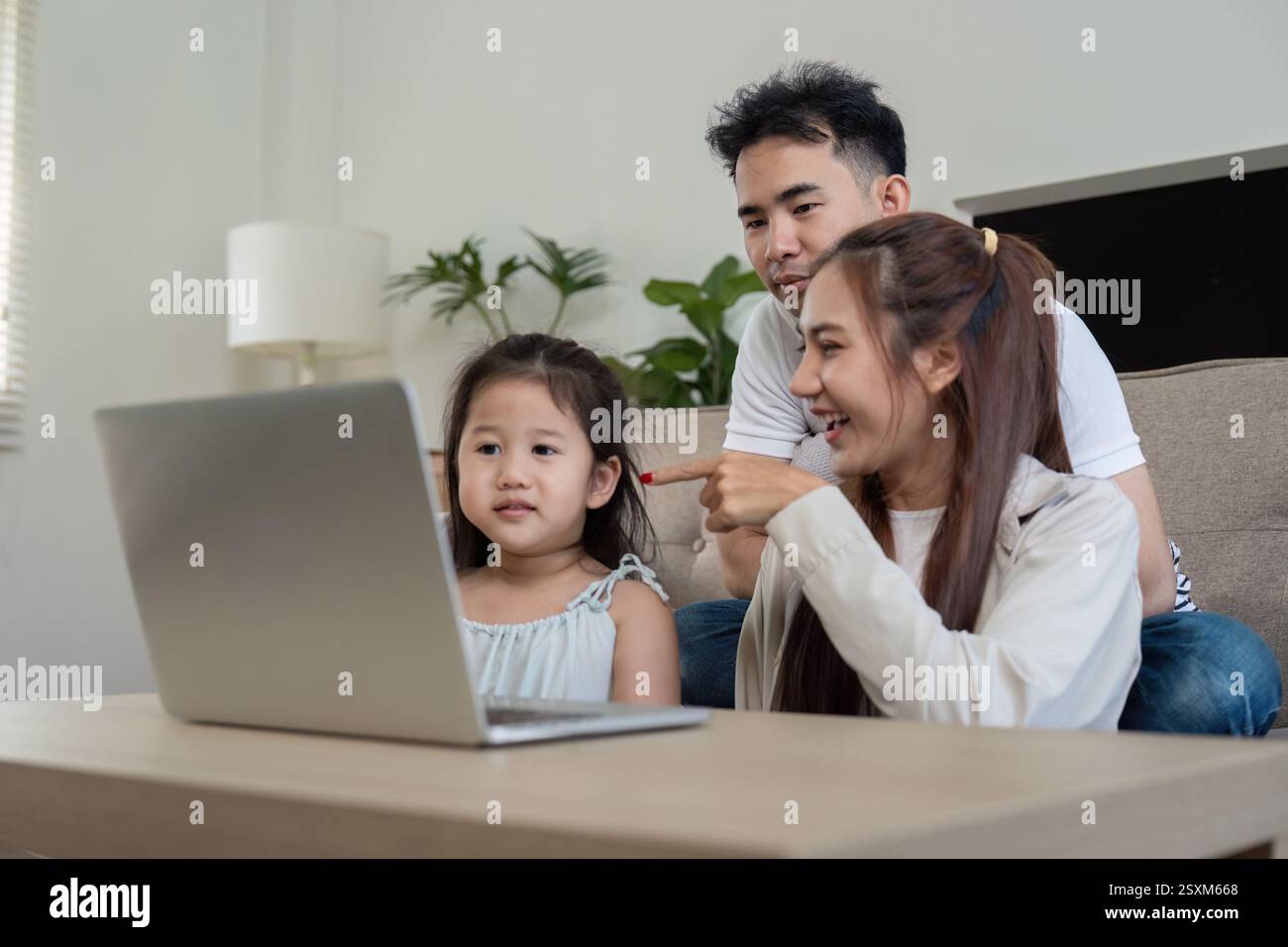 Family watching a movie together, sharing smiles and joy Stock Photo ...