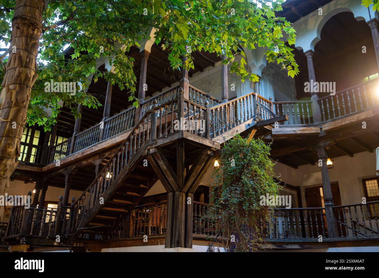 A beautiful courtyard in Bucharest showcases wooden architecture with a ...