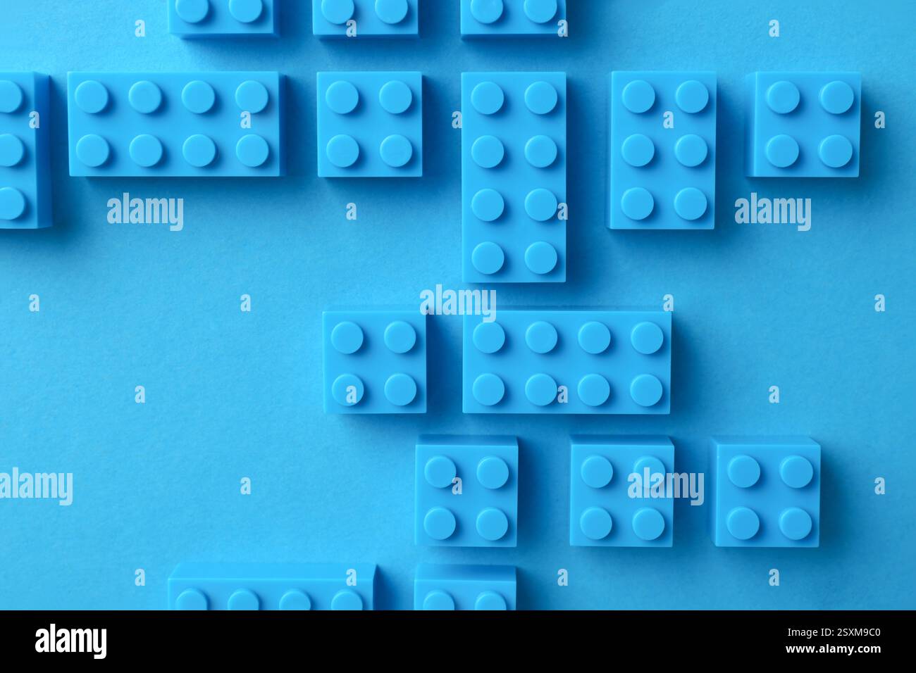 Constructor toy. Many building blocks on light blue background, flat ...