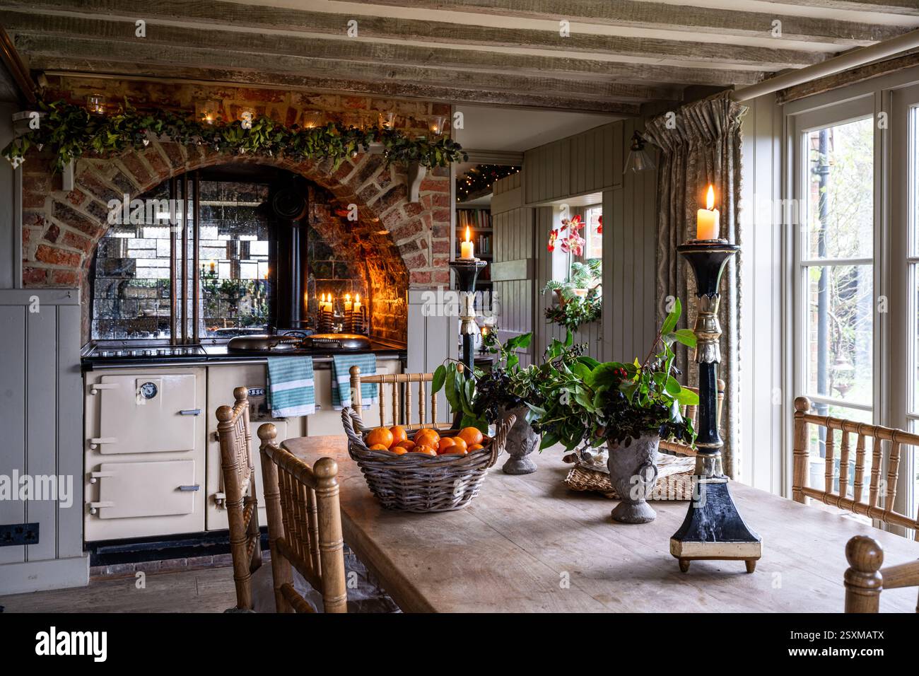 Mirrored tiles behind cast-iron Esse range cooker reflecting ...