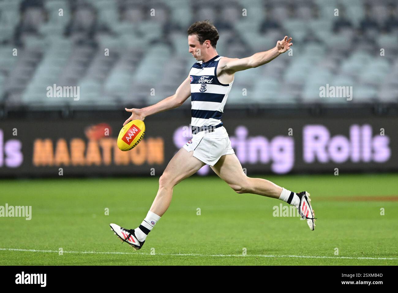 Max Holmes of Geelong kicks the footy during the AFL Community Series match between the Geelong ...