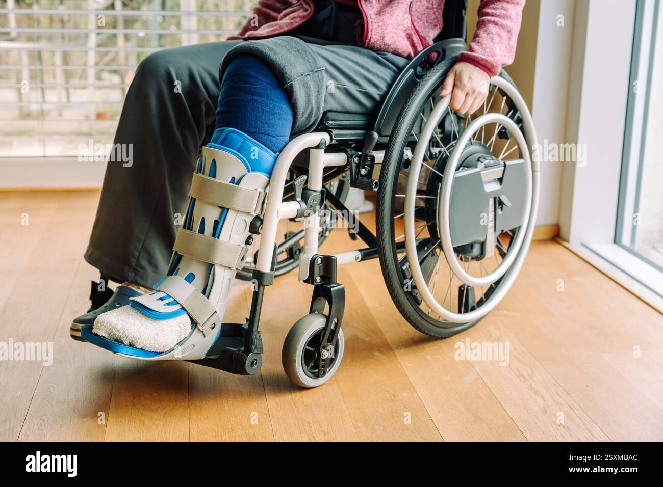 Detail or woman in a wheelchair with leg brace after sport injury Stock ...