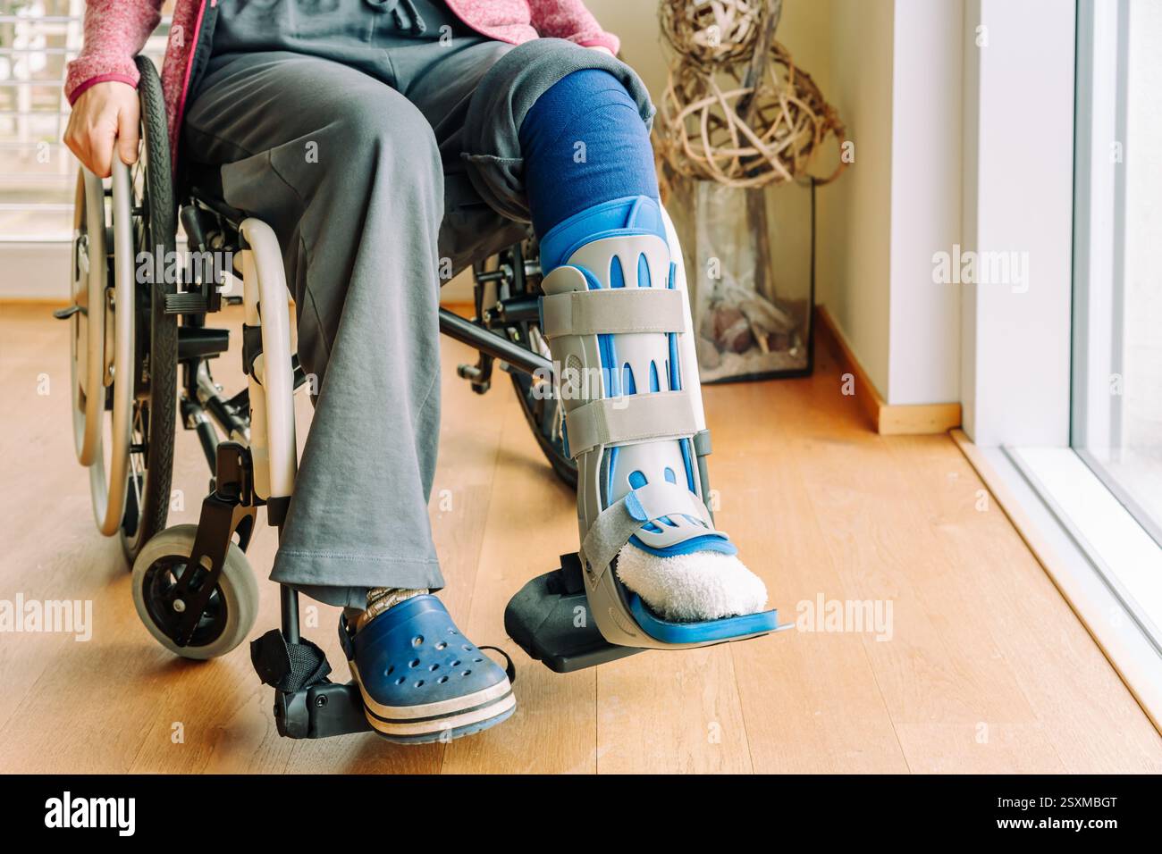 Detail or woman in a wheelchair with leg brace after sport injury Stock ...
