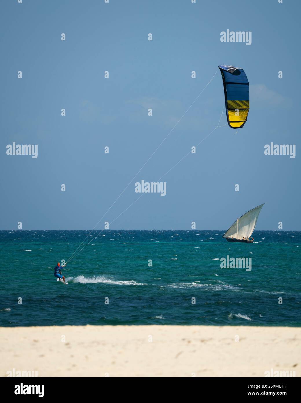 Kitesurfer surfing on a flat azure water of ocean in Zanzibar island ...