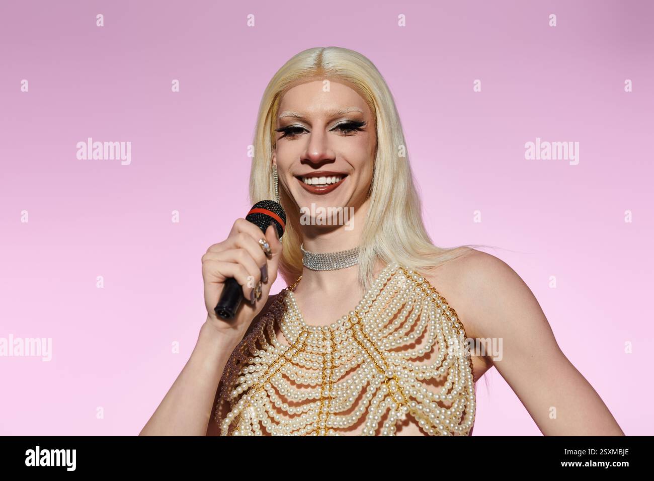 A confident young drag queen performs on stage, exuding style and flair ...