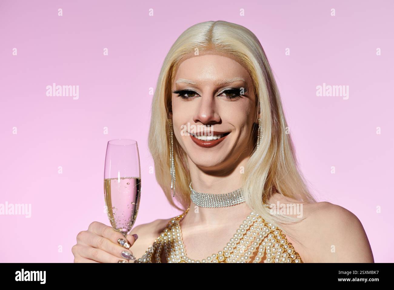 An elegant drag queen proudly holds a glass of bubbly, radiating ...