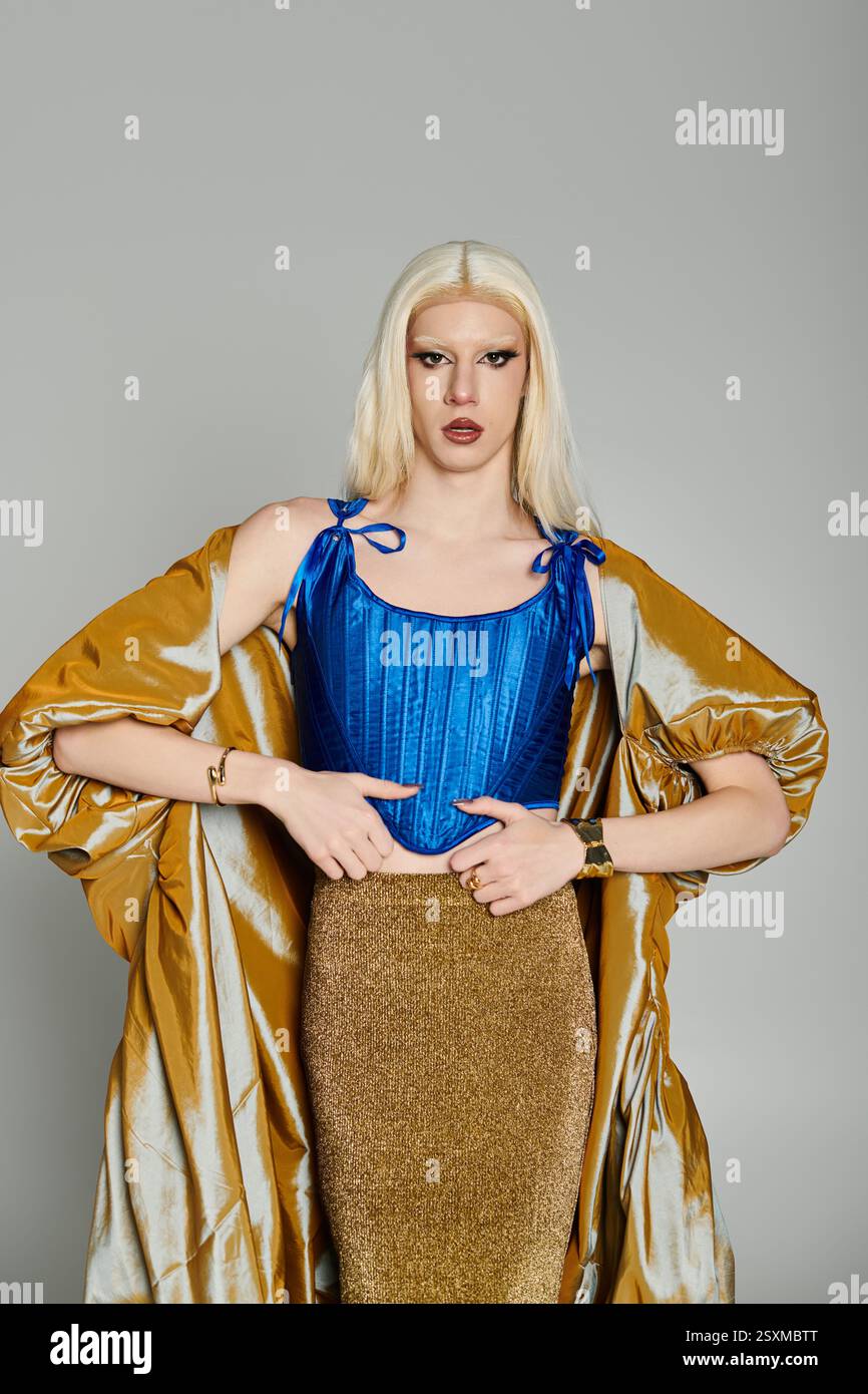 A drag queen captivates with a bold blue outfit and shimmering gold ...