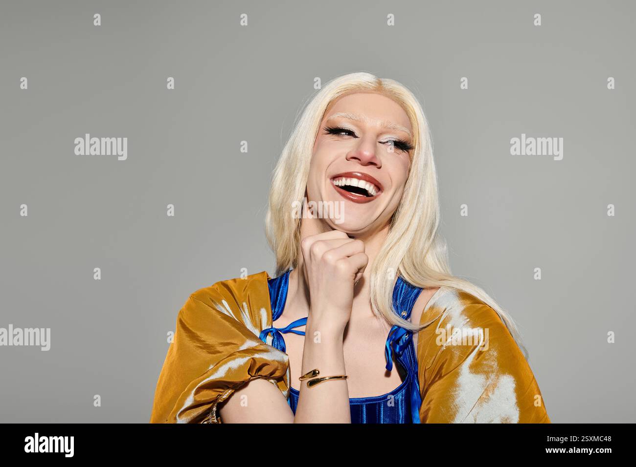 This stylish young drag queen showcases a confident smile, radiating charisma and flair Stock ...