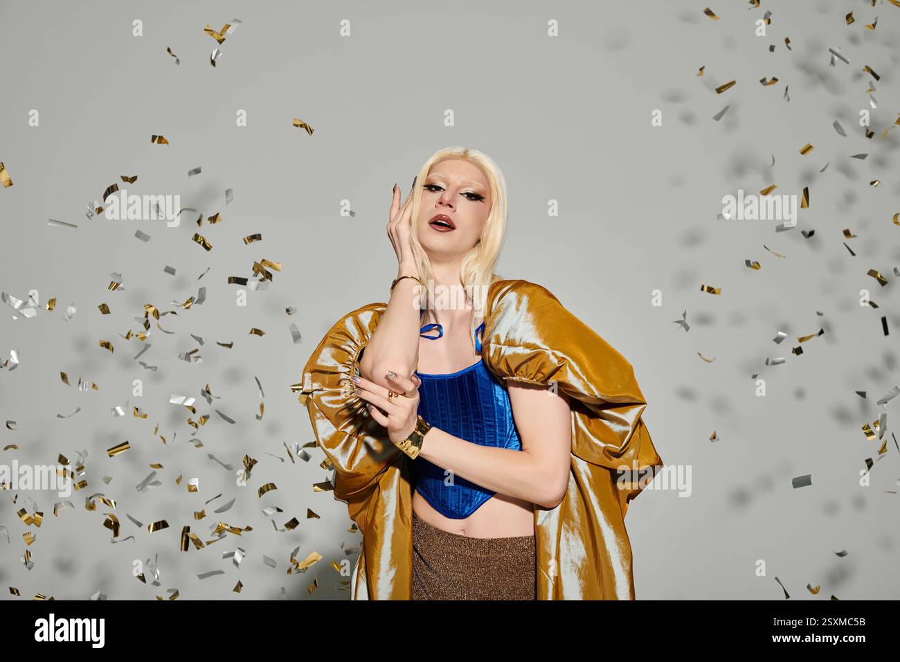 A chic drag queen showcases their style in a festive, confetti filled ...