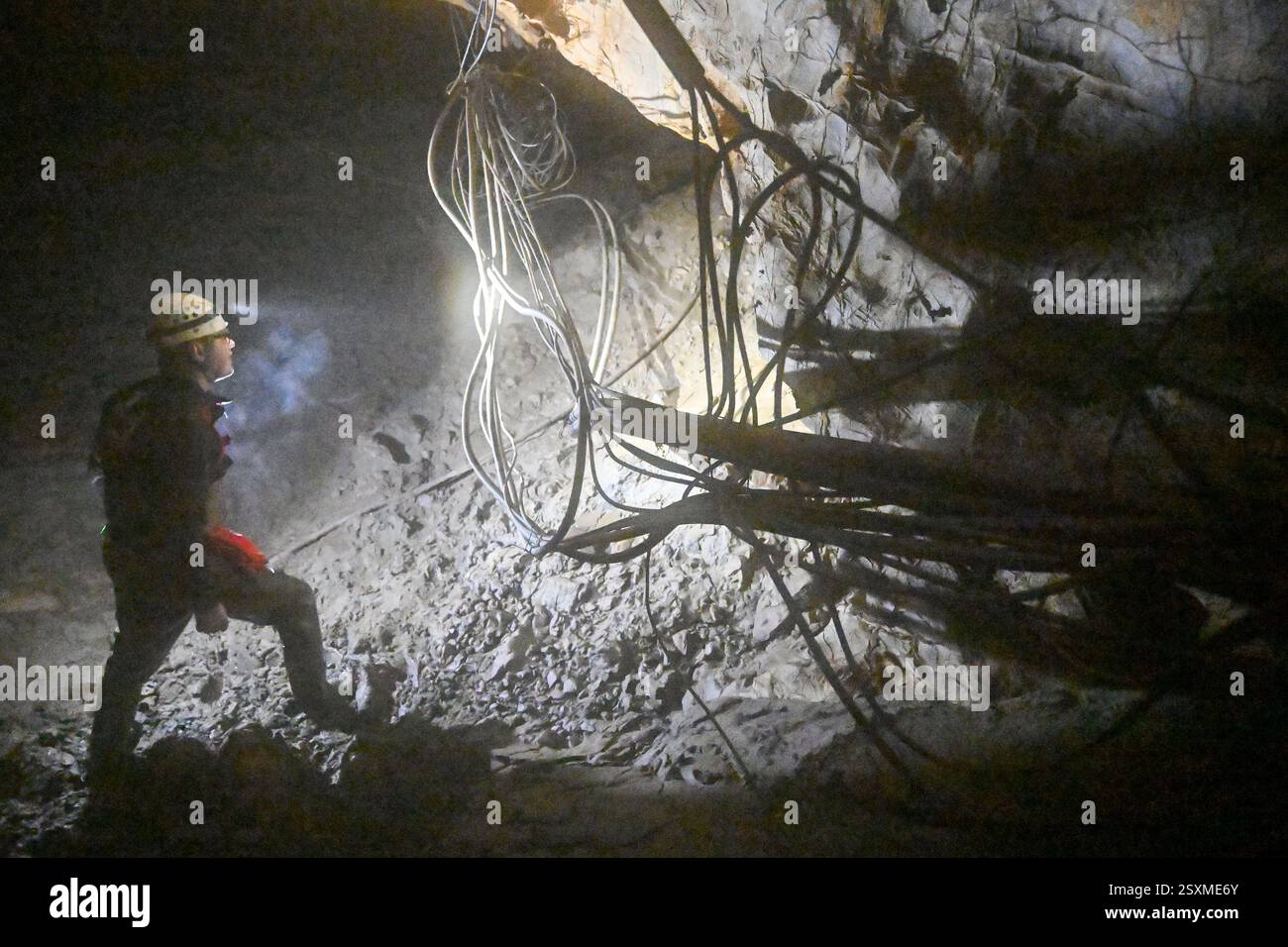 Workers repair electrical installation in tourist route along the ...