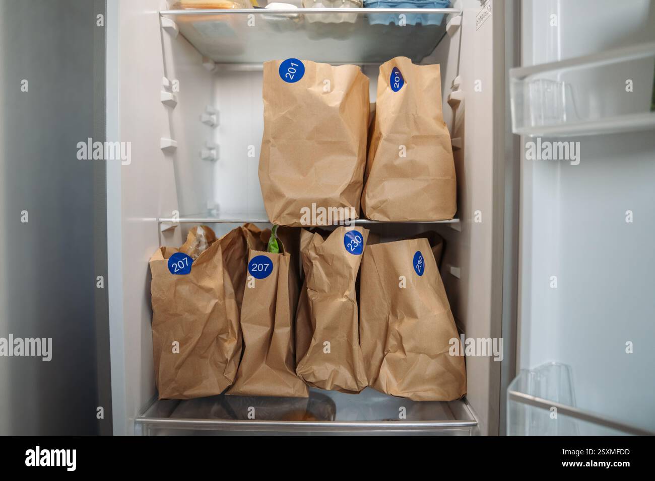 Groceries in brown paper bags in the fridge Stock Photo - Alamy