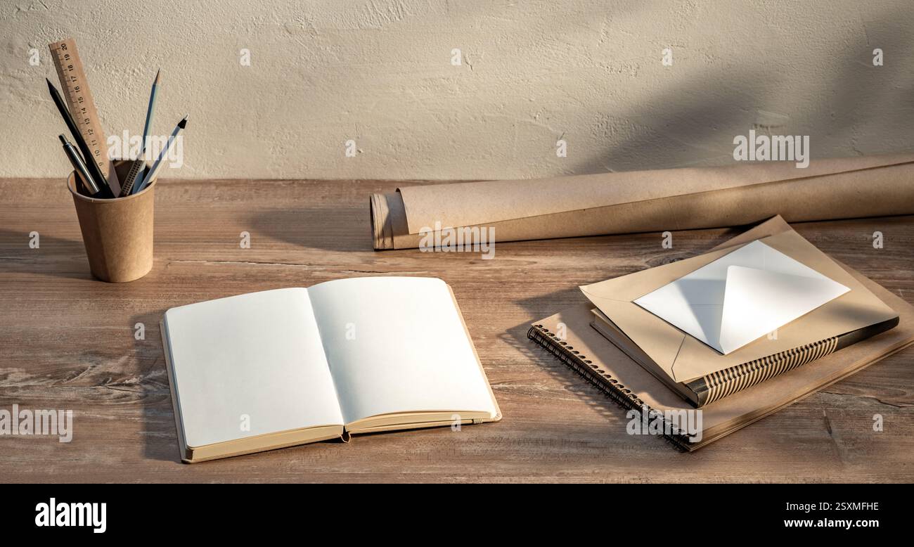 A workspace showcases various stationery items on a wooden desk ...