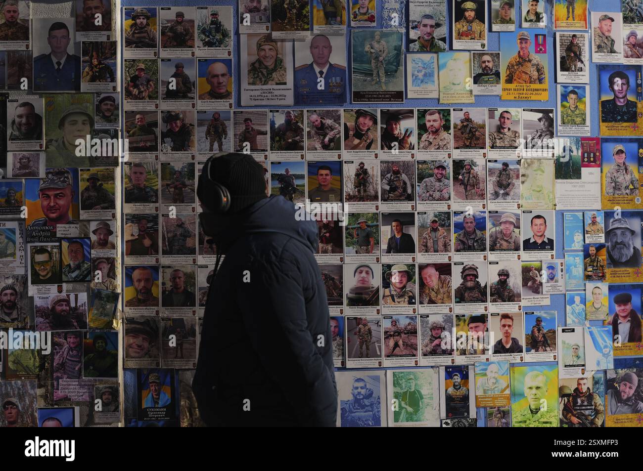 Portraits of the fallen are seen on the outside wall of St. Michael's ...