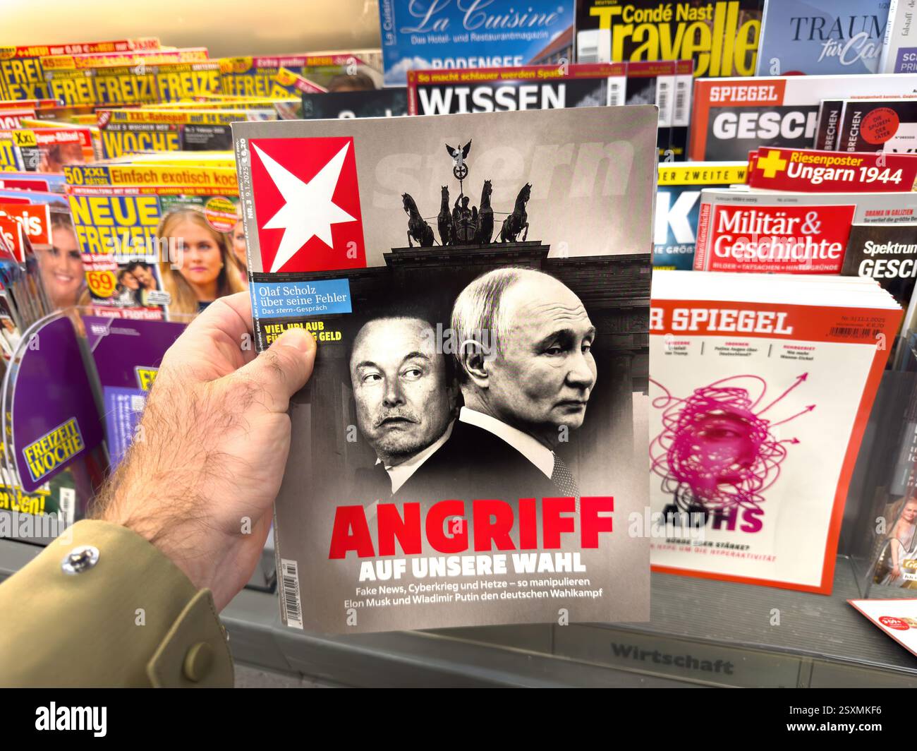 Berlin, Germany - Jan 111, 2025: A person holds a German magazine ...