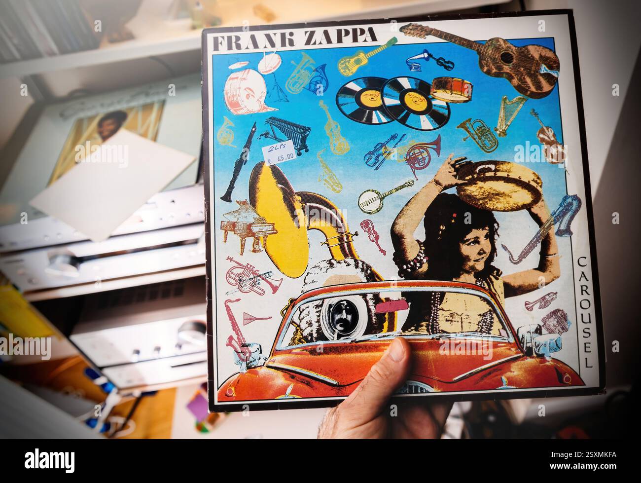 Paris, France - Feb 17, 2025: A hand holding a Frank Zappa Carousel LP ...