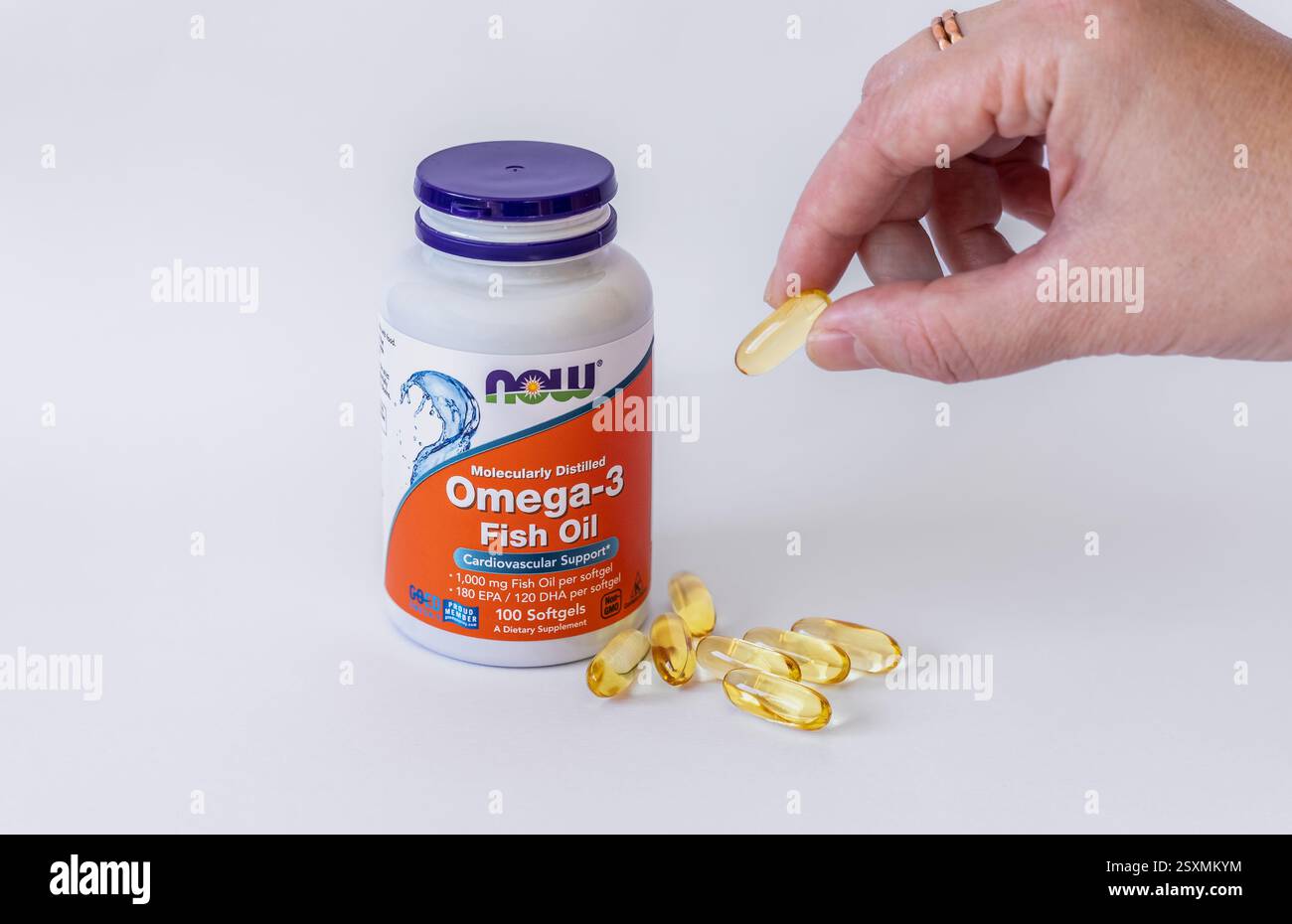 Now soft gels, natural Fish oil capsules, omega 3, vitamin E. Hands ...