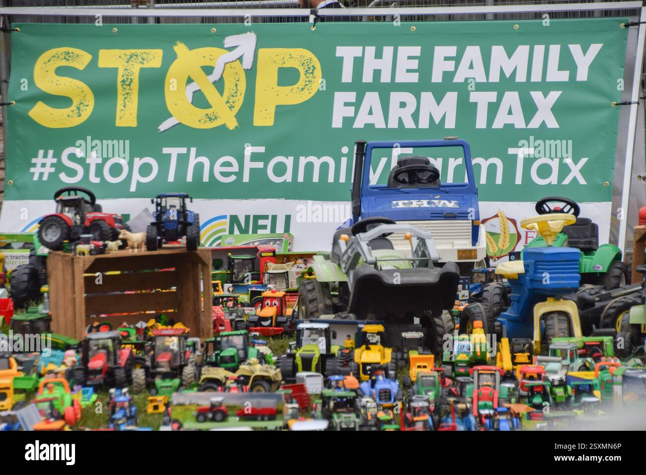 London, UK. 25th February 2025. Farmers display toy tractors outside ...