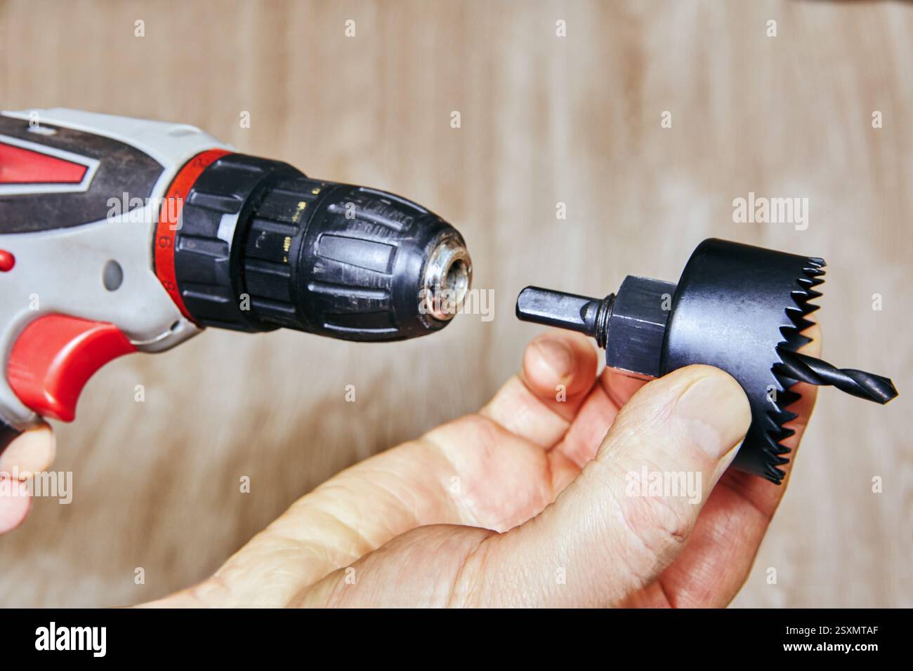 Power drill with deadbolt hole saw cutter is prepped for efficient door ...