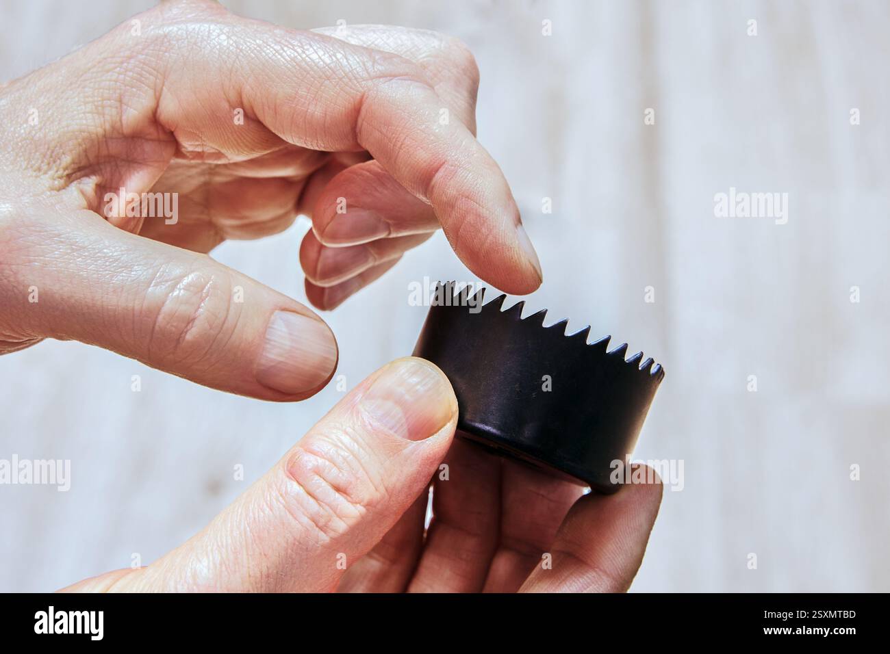 Saw tool with jagged edges used for cutting circular sections in ...