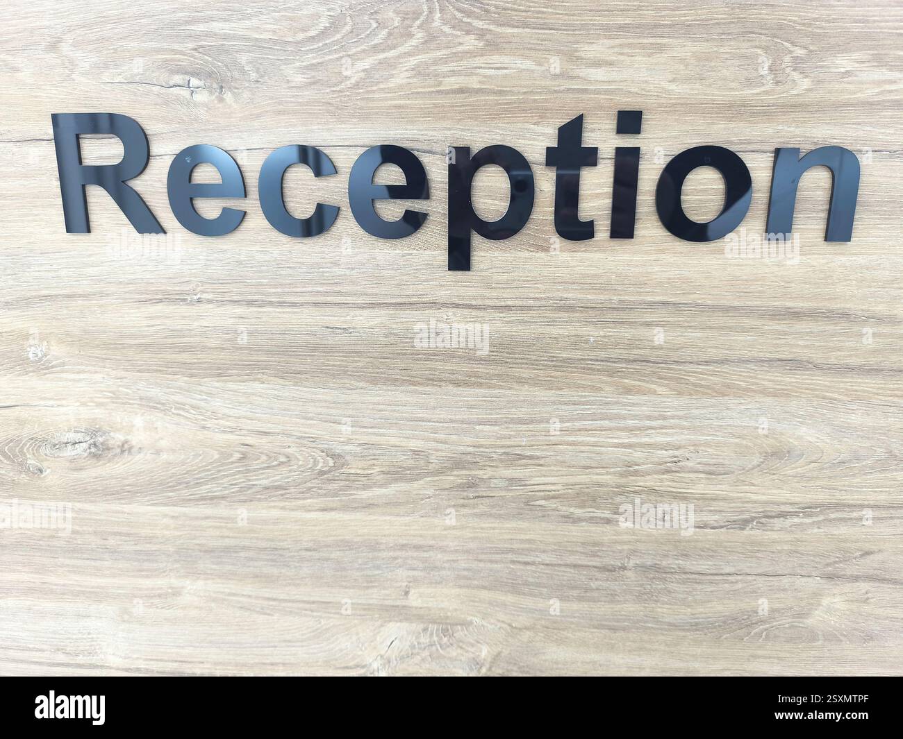 Reception sign on wooden wall background in modern office setting Stock ...