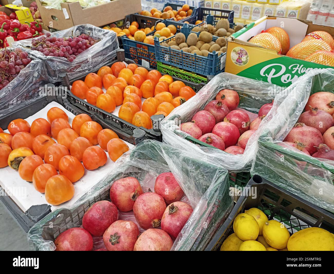 Assorted fruits display: persimmons, pomegranates, kiwis, and more at ...
