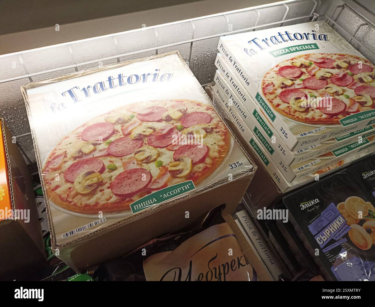 Frozen pizza boxes in store freezer featuring pepperoni and mushroom ...