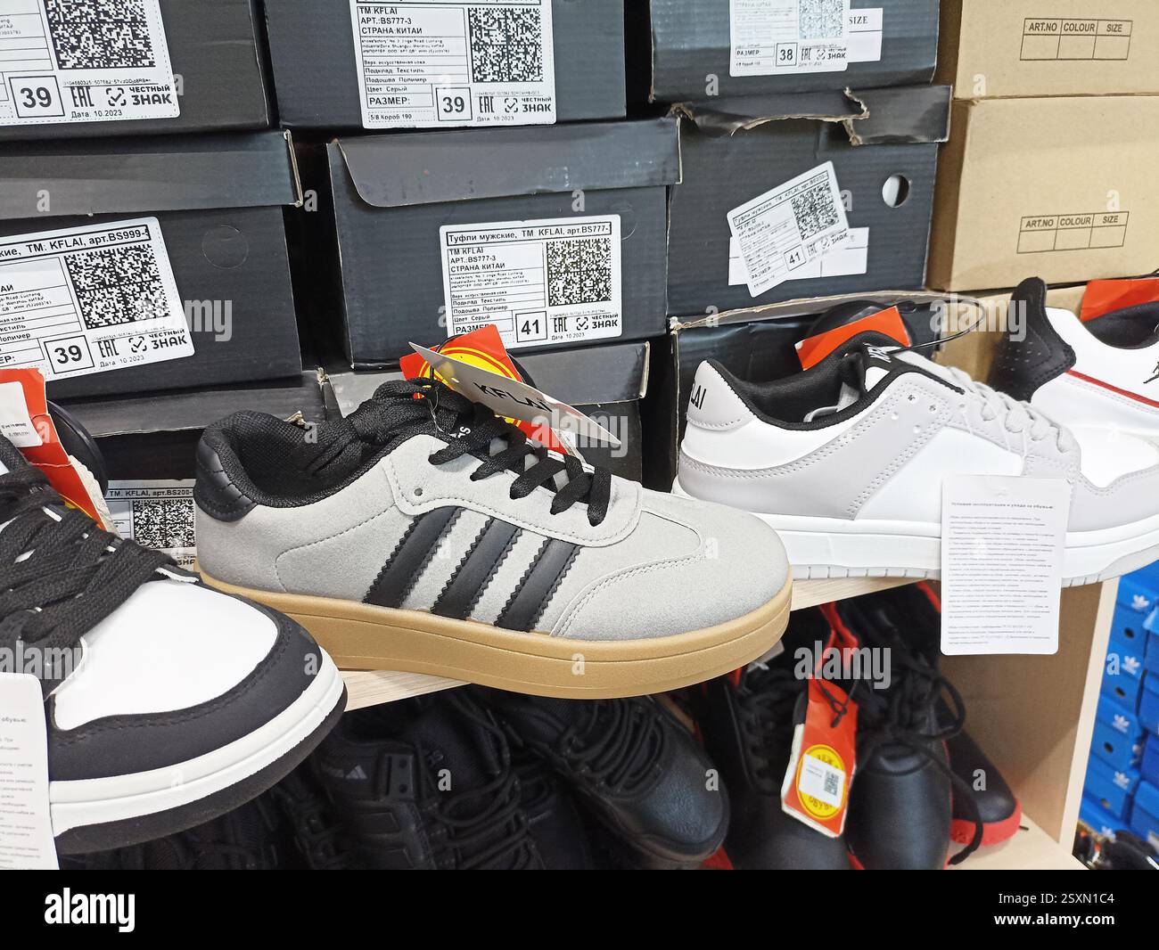 Variety of sneakers with labels displayed in shoe store Stock Photo - Alamy