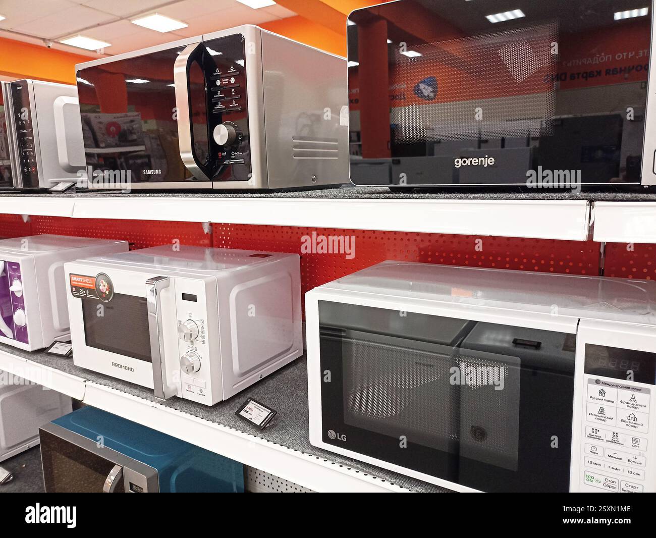 Selection of modern microwaves on display in electronics store Stock Photo - Alamy