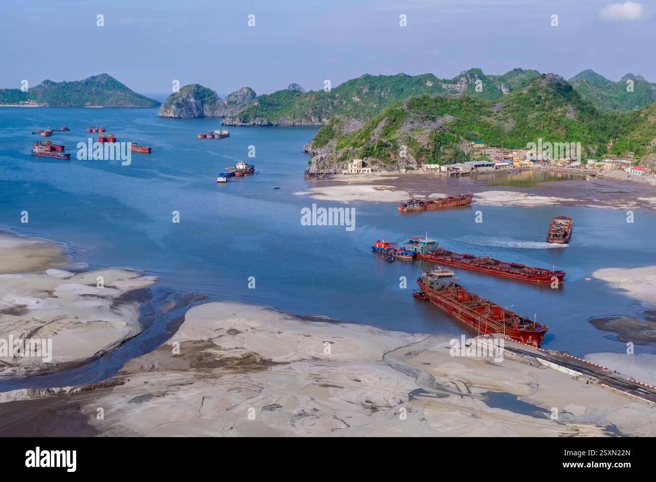 Aerial view of the filling of Cat Ba Bay with sand as part of the ...