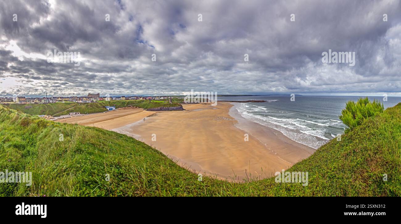 Golden sand and rugged cliffs at Ballybunion Beach in Ireland during ...