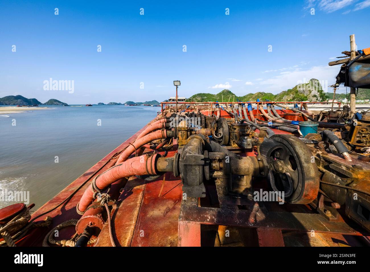 Pump ships filling the bay of Cat Ba with sand as part of the ...