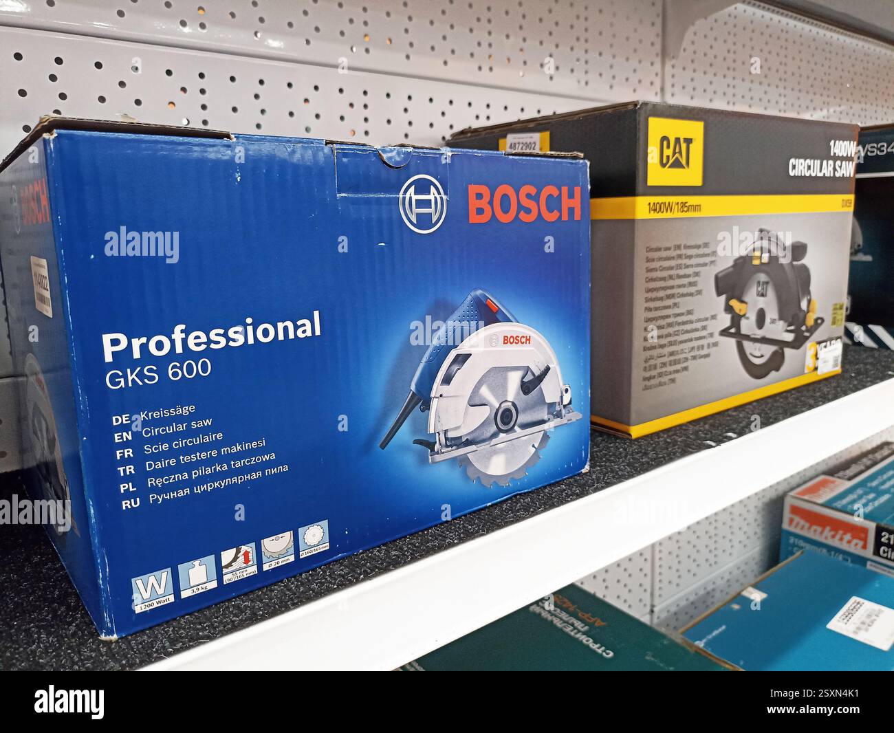 Bosch and cat circular saws on hardware store shelf with multi-language ...