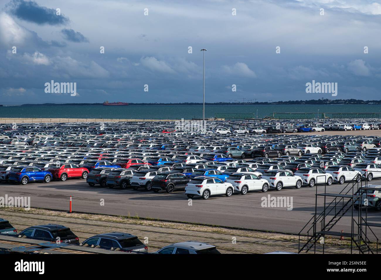 Aerial view of a vast parking lot at seaport cargo terminal. Rows of ...
