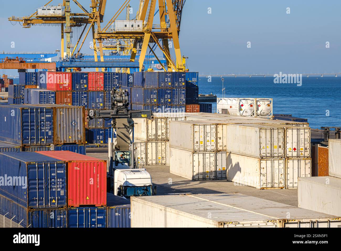 Cargo containers stacked on berth of sea port on sunny day. Maritime ...