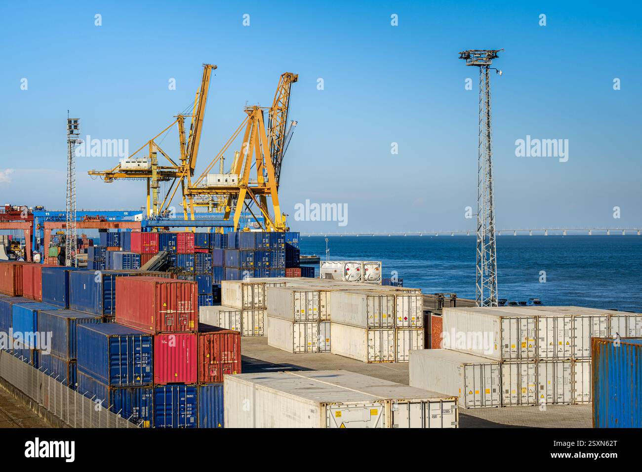 Cargo containers stacked on berth of sea port on sunny day. Maritime ...