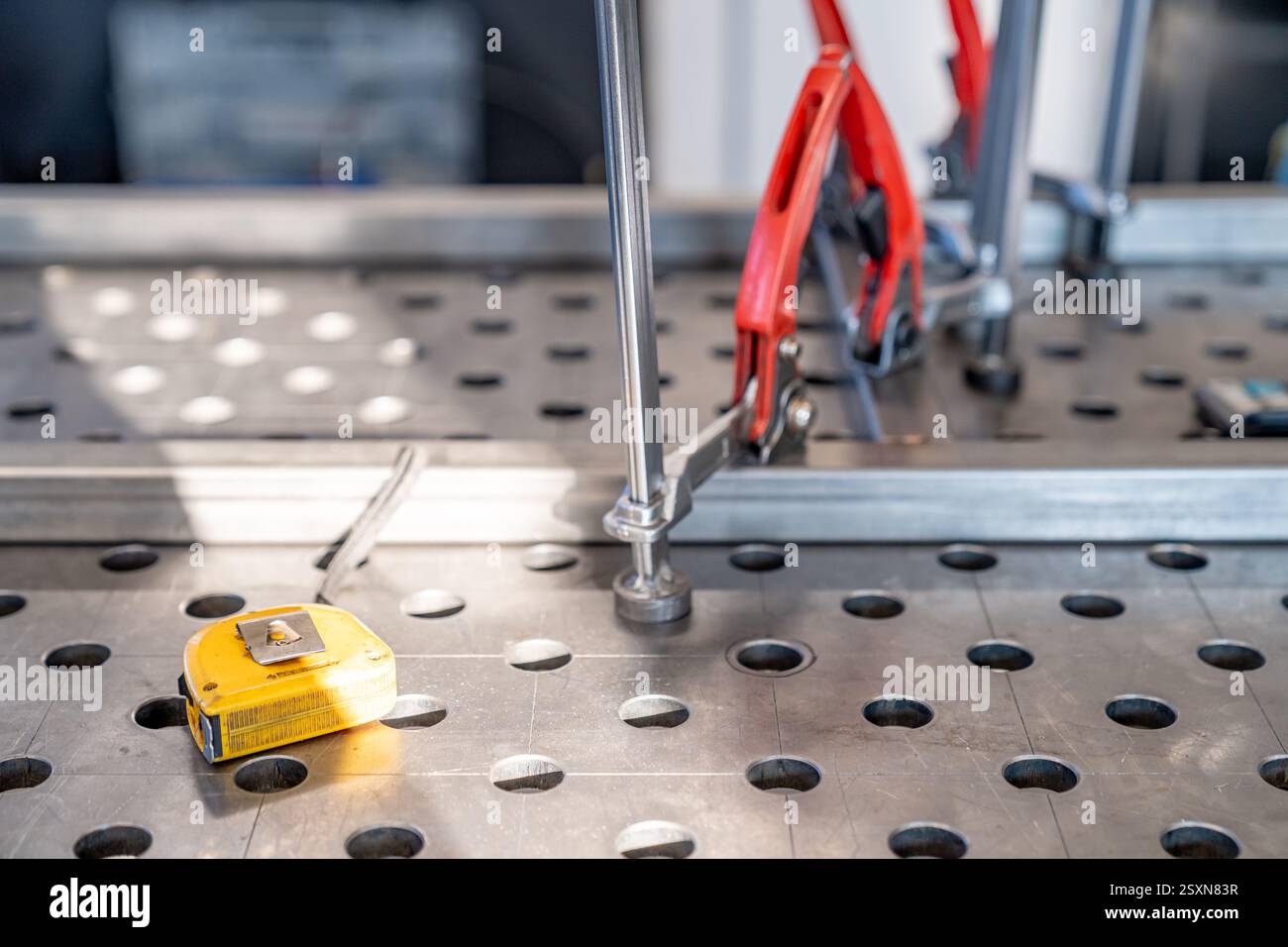 Welding table with clamps, measuring tape, and metal profiles in ...