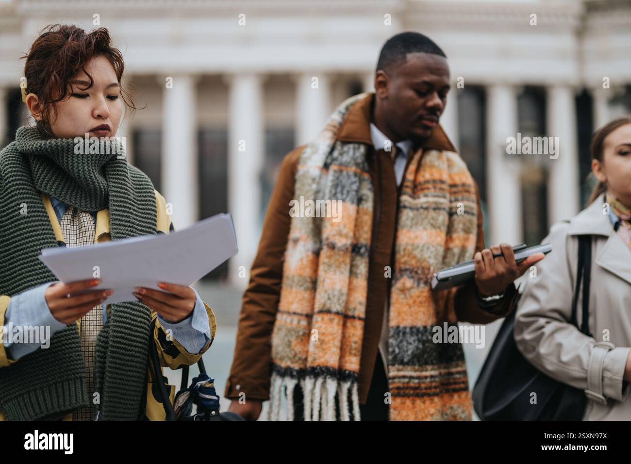 Group of people reviewing documents outdoors on a wintery day Stock ...