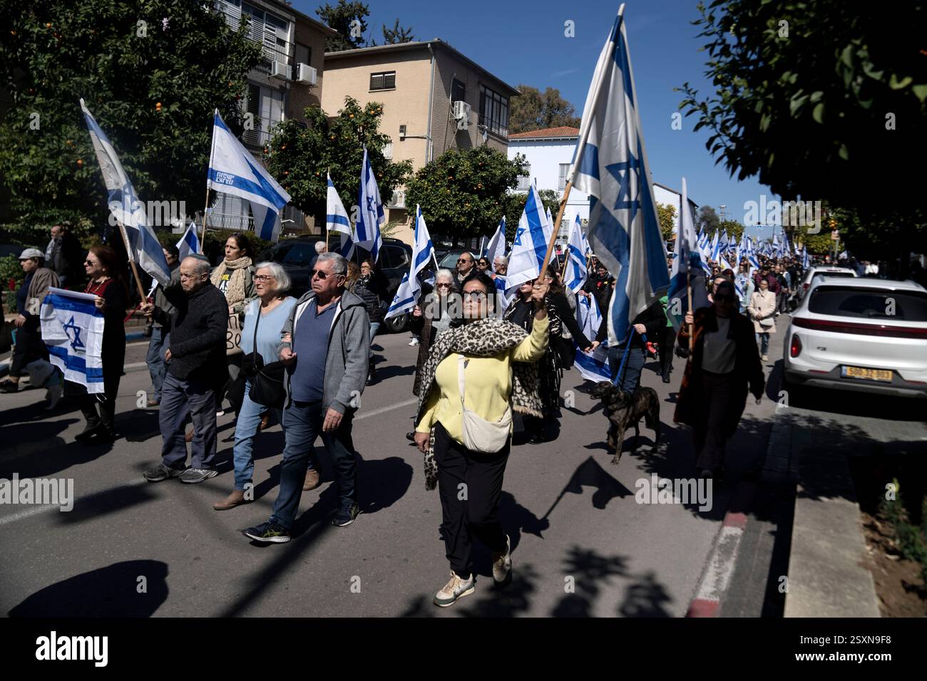 Mourners march behind a van carrying the body of former hostage Oded ...