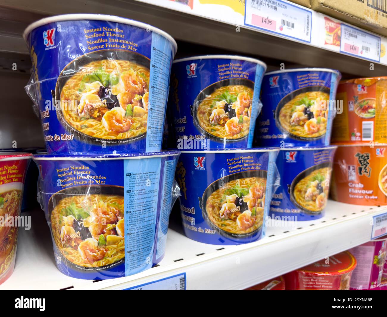 Instant seafood noodles line shelves in vibrant packaging at local ...