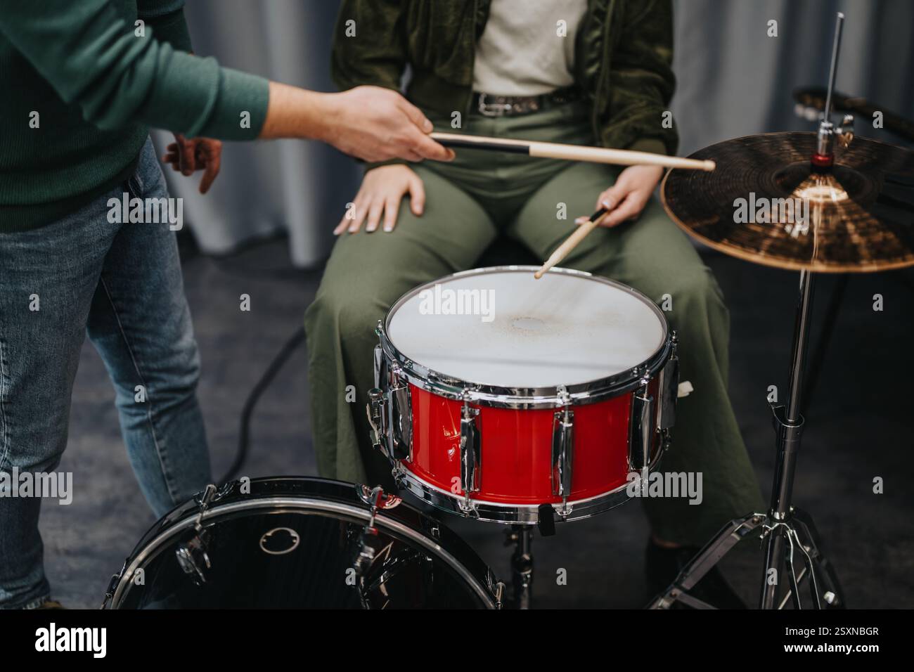 Drumming Lesson at a Music Studio with a Red Drum Set Stock Photo - Alamy