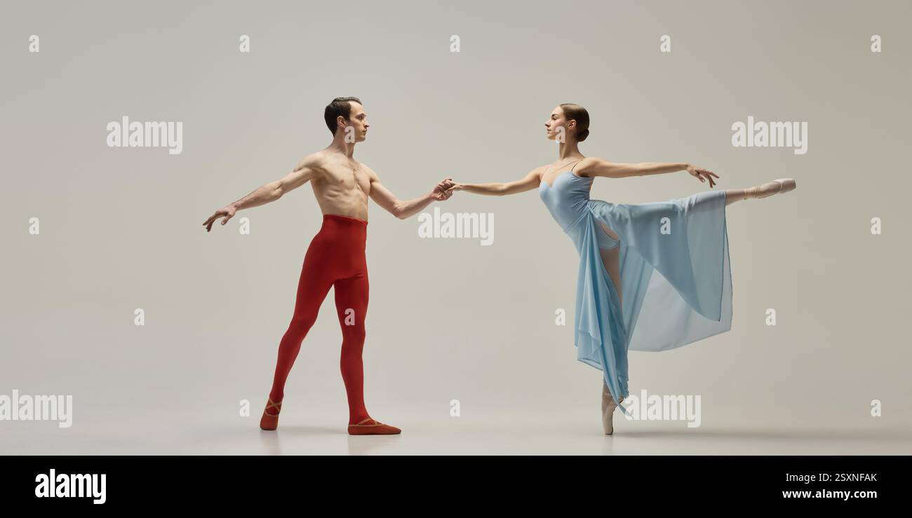 Ballet duet creating dynamic diagonal, one reaching outward, other ...