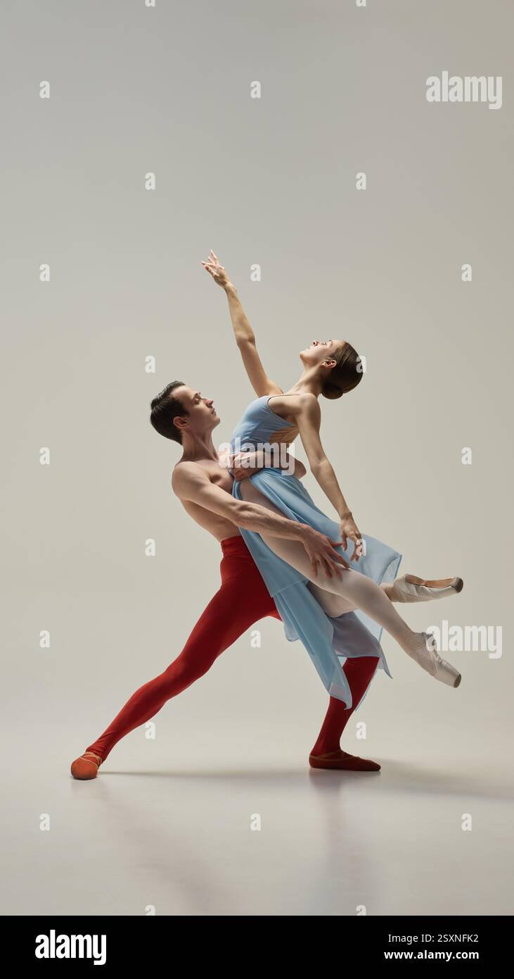Ballerina lifted in graceful arch, arms reaching toward sky, male ...