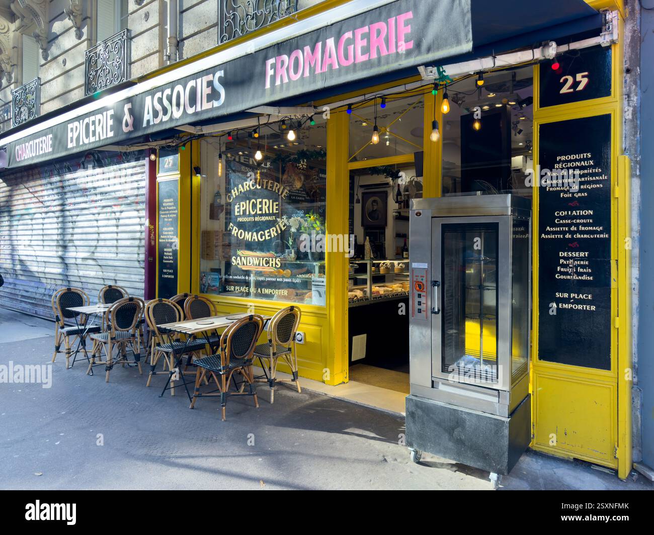 Charming corner shop with outdoor seating and colorful awnings in Paris ...