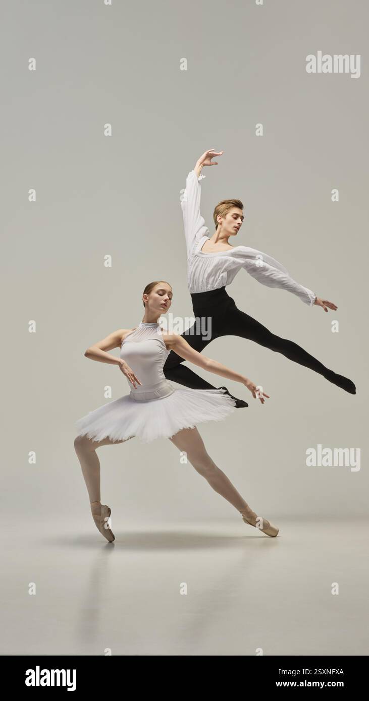 Ballet partners creating mirrored lines in airborne movement, extending ...