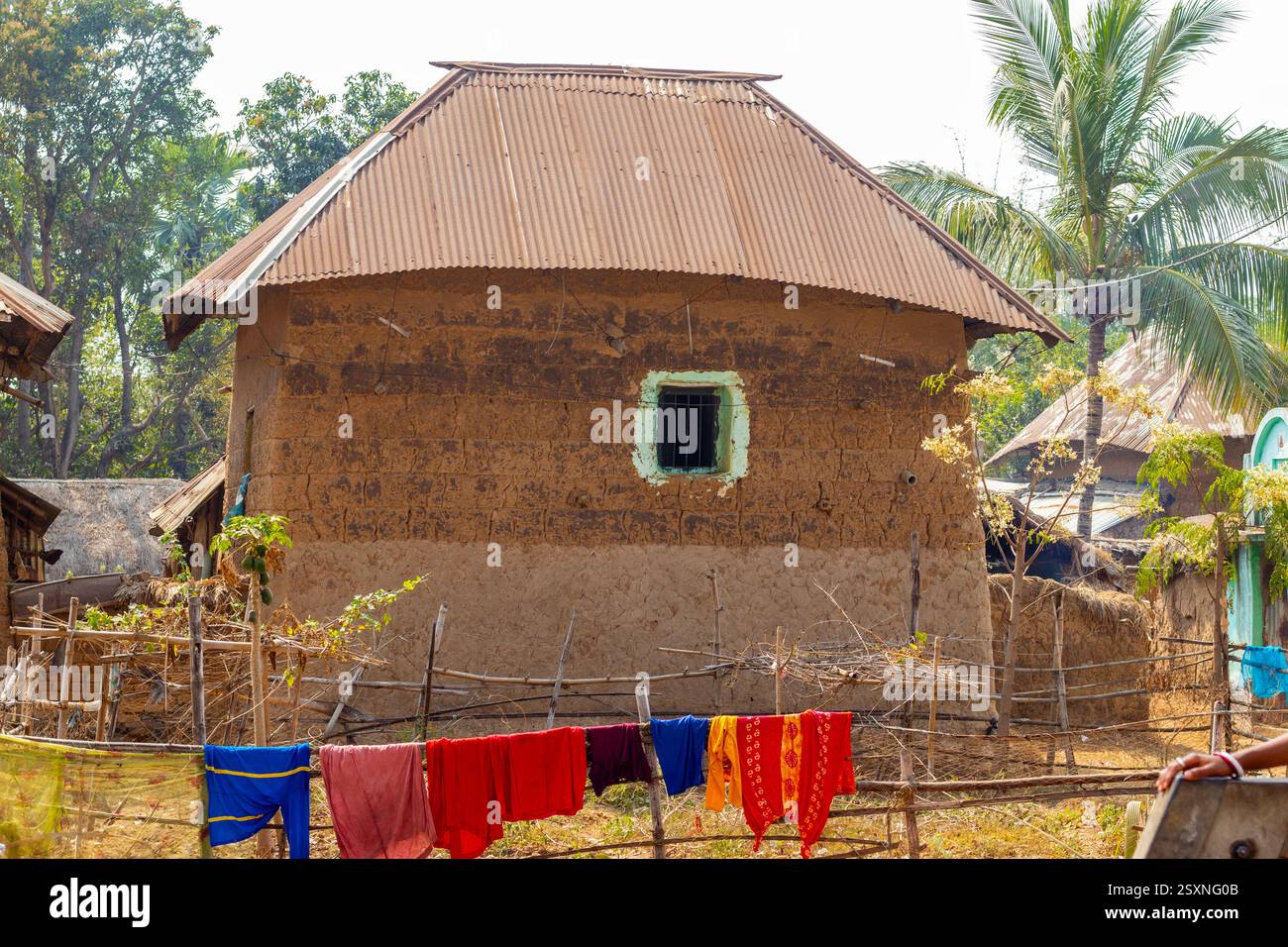 a traditional Indian village mud house with a corrugated metal roof ...