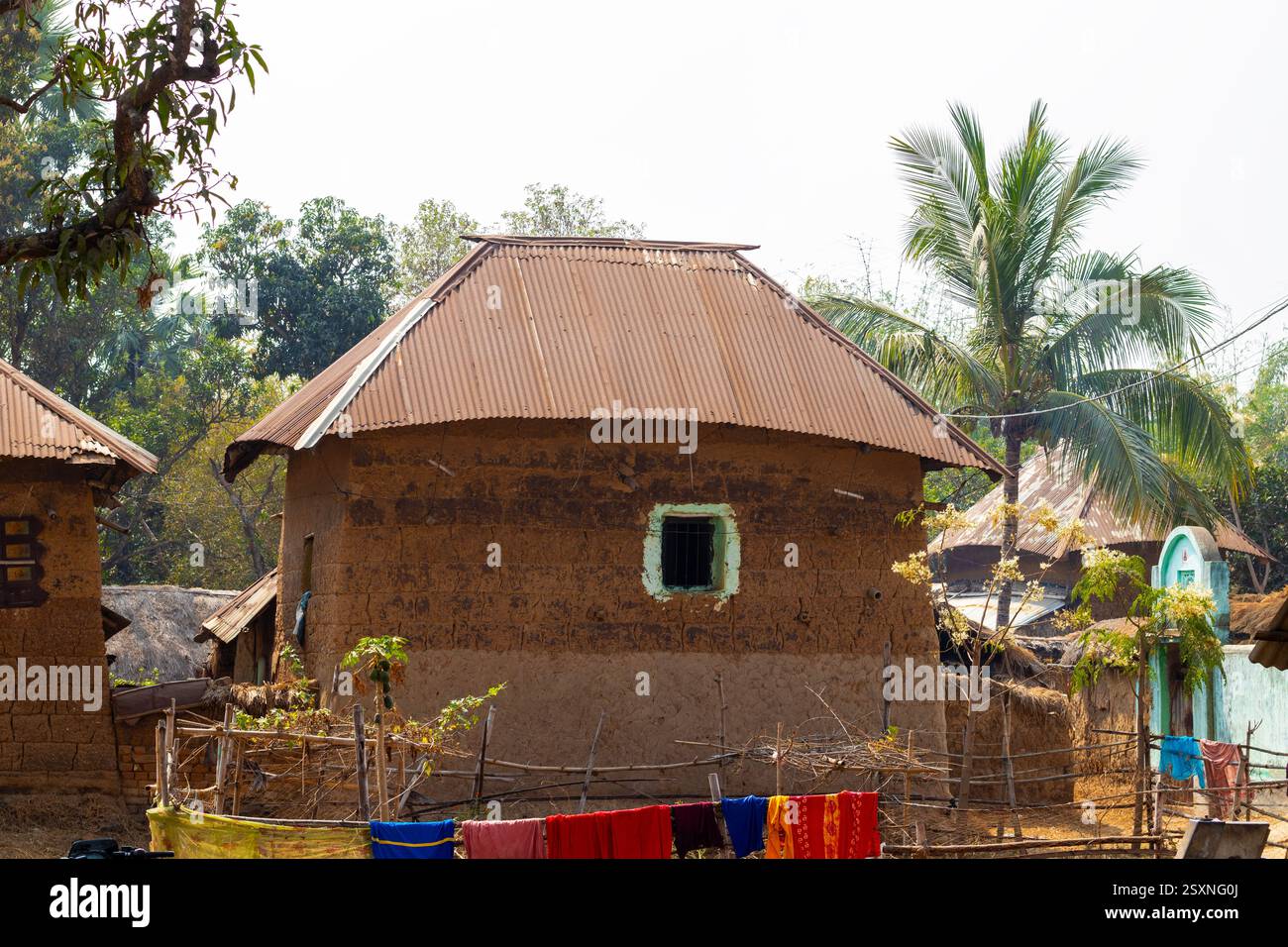 a traditional Indian village mud house with a corrugated metal roof ...