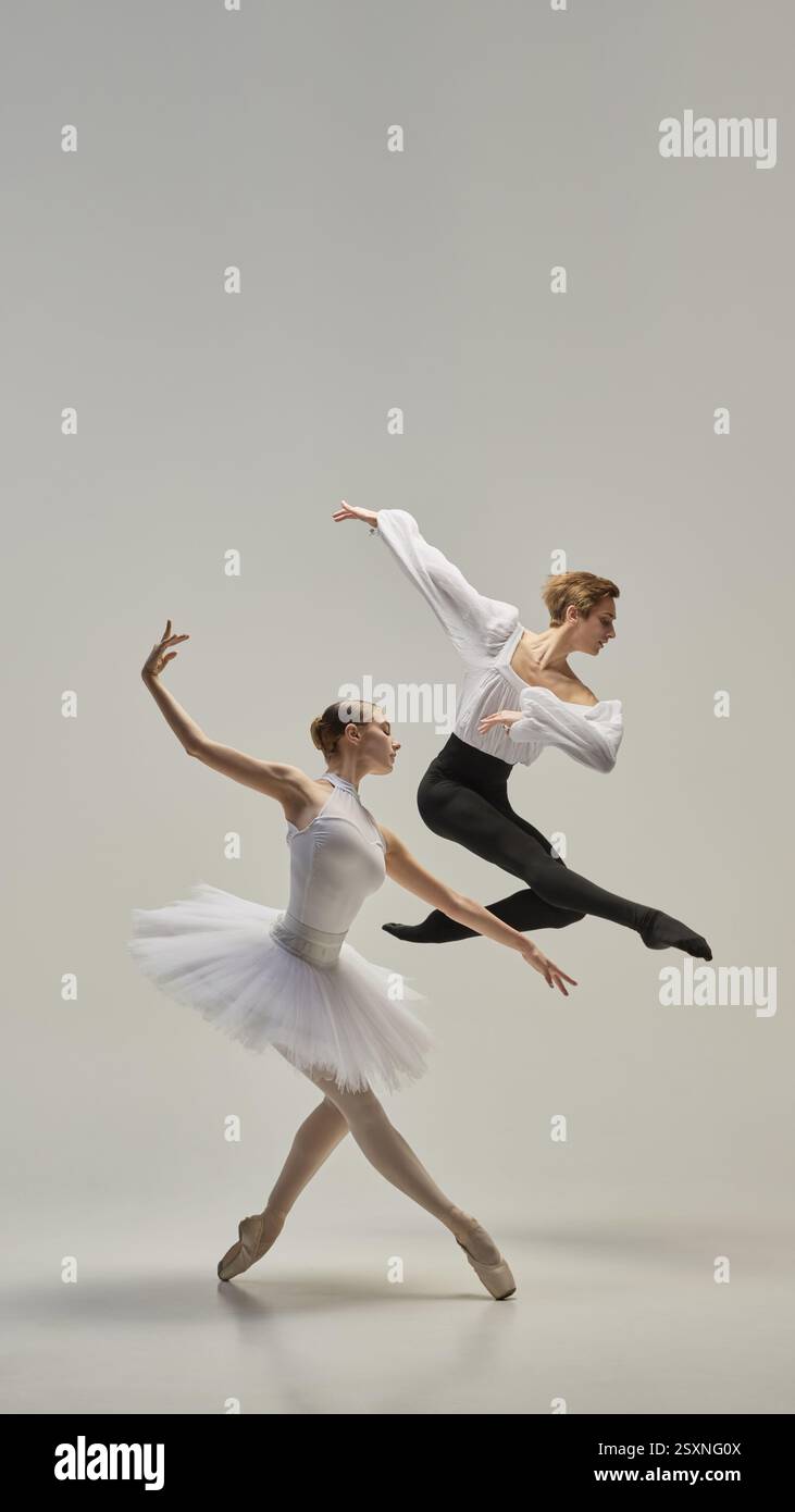 Ballet dancers performing synchronized leap, arms and legs fully ...
